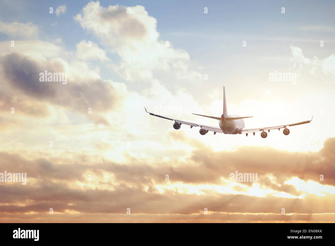 airplane in sunset sky Stock Photo - Alamy