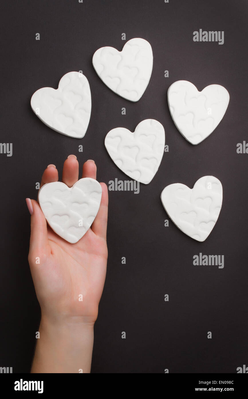 Hand holding little hearts Stock Photo - Alamy