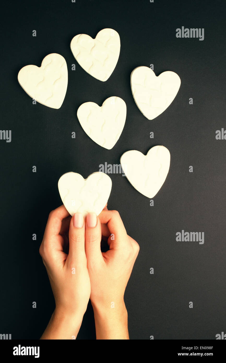 Hand holding little hearts Stock Photo - Alamy