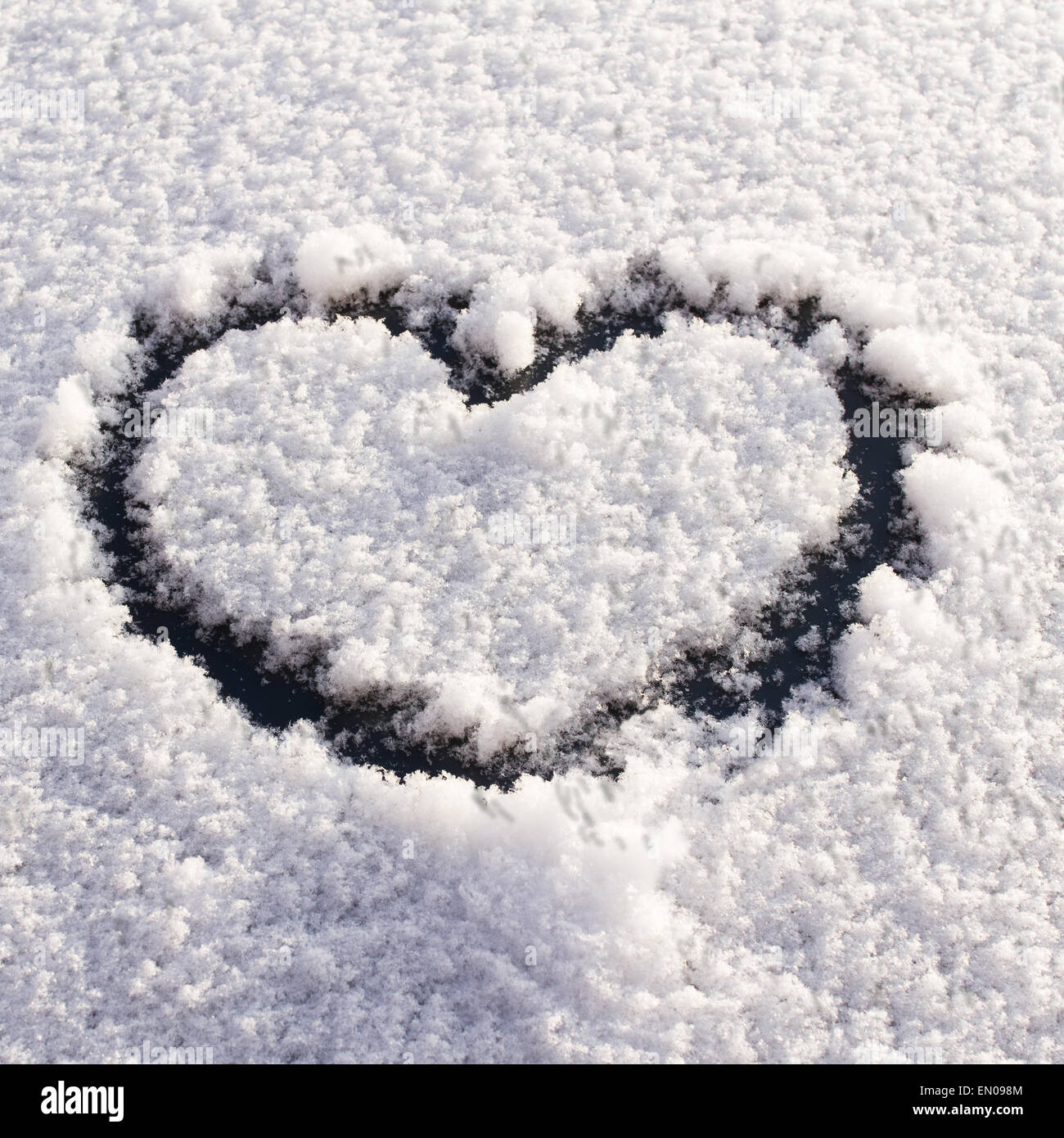 Heart shape on snow Stock Photo - Alamy