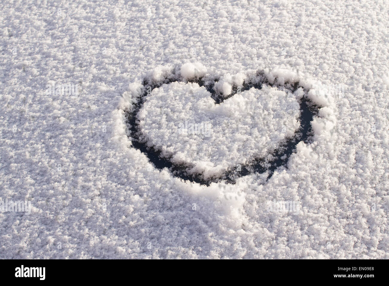Heart shape on snow Stock Photo - Alamy