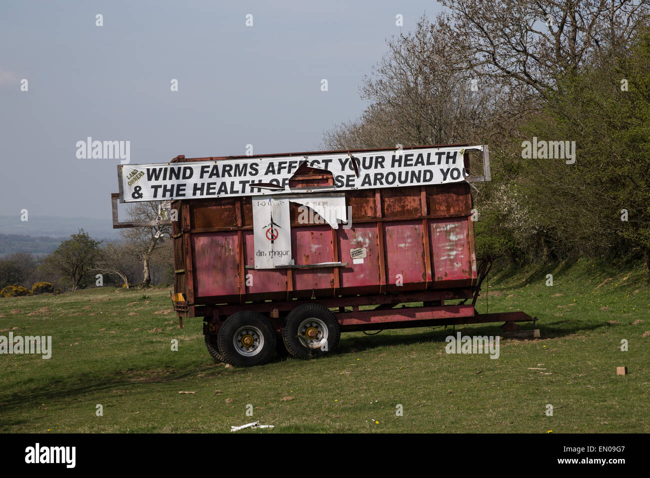 Old rusty farm silage trailer with broken sign reading "Wind farms ...