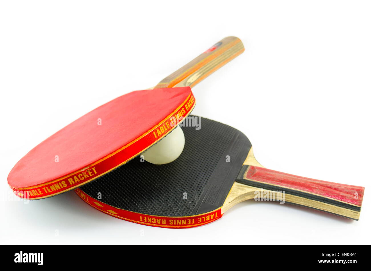 Two ping-pong rackets and a ball between isolated Stock Photo - Alamy