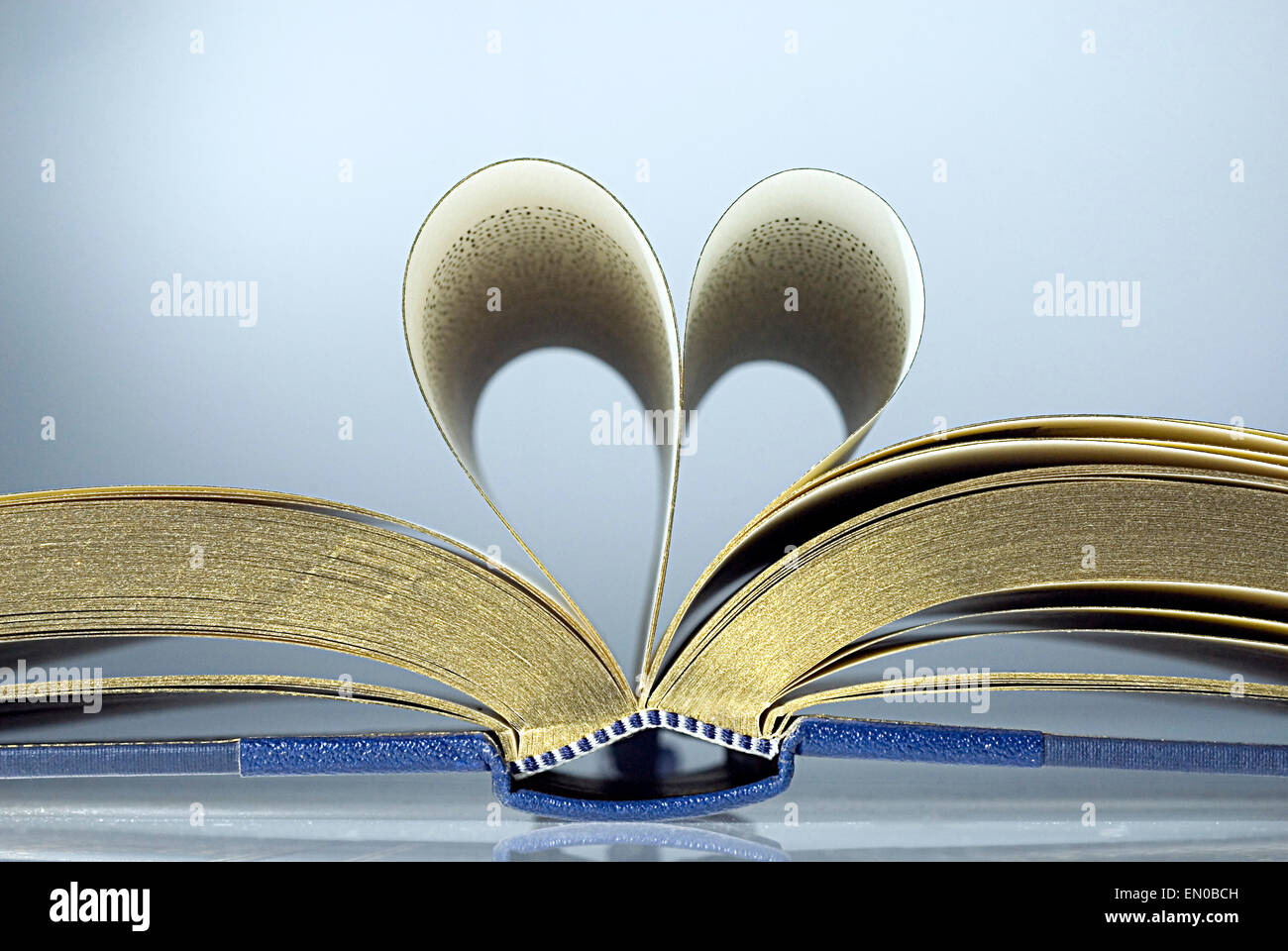 Open book, two pages folded into the shape of a heart Stock Photo - Alamy