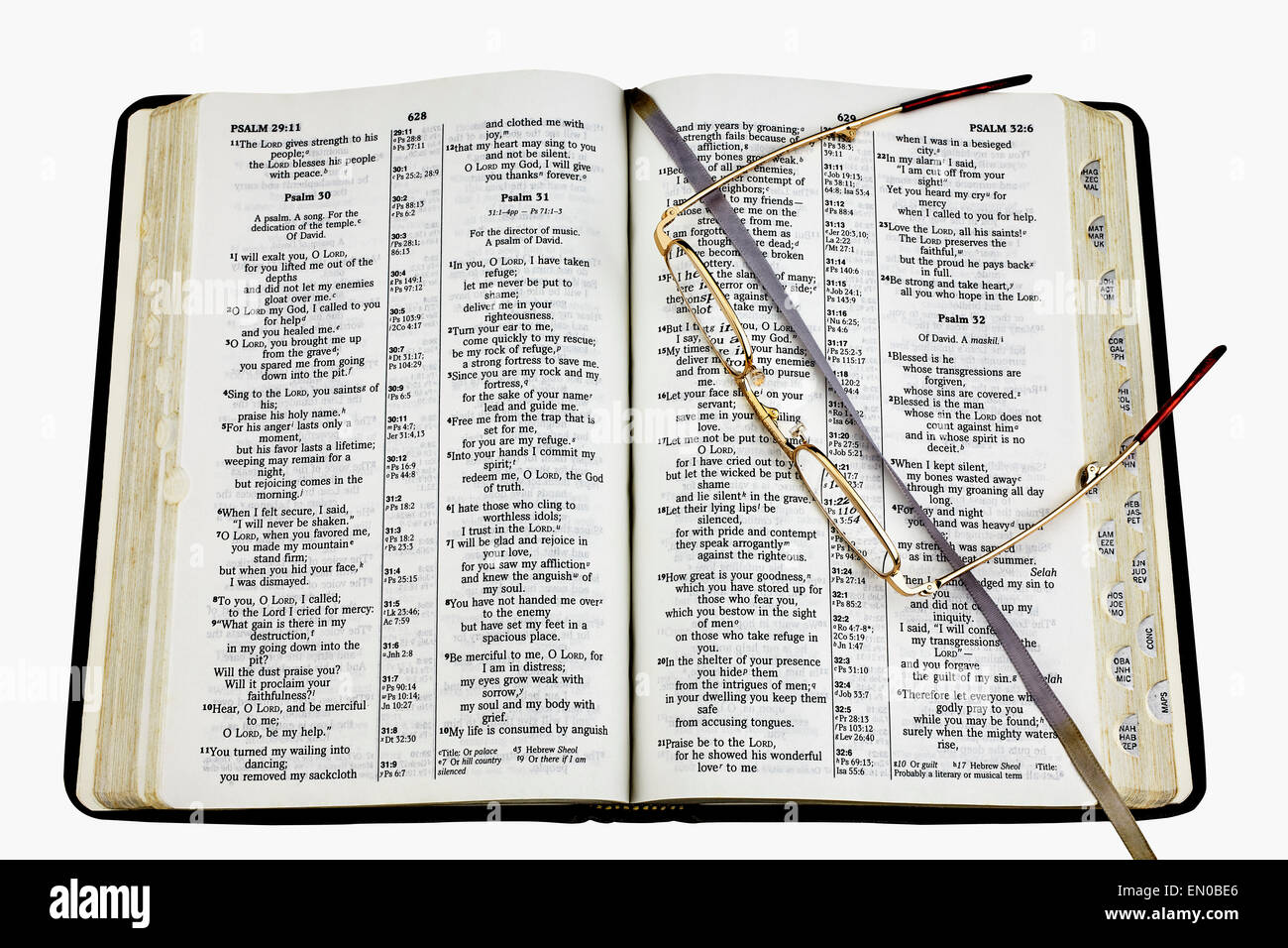 Generic Holy Bible turned to a passage on Psalms with reading glasses ...