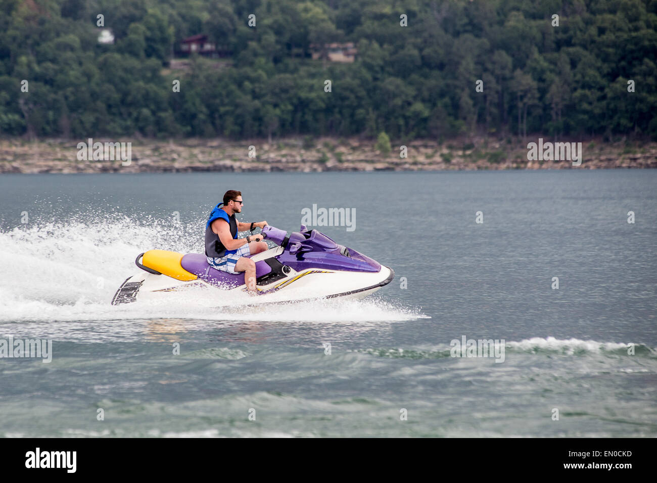 Young man riding jet boat on a summer day at the lake Stock Photo - Alamy