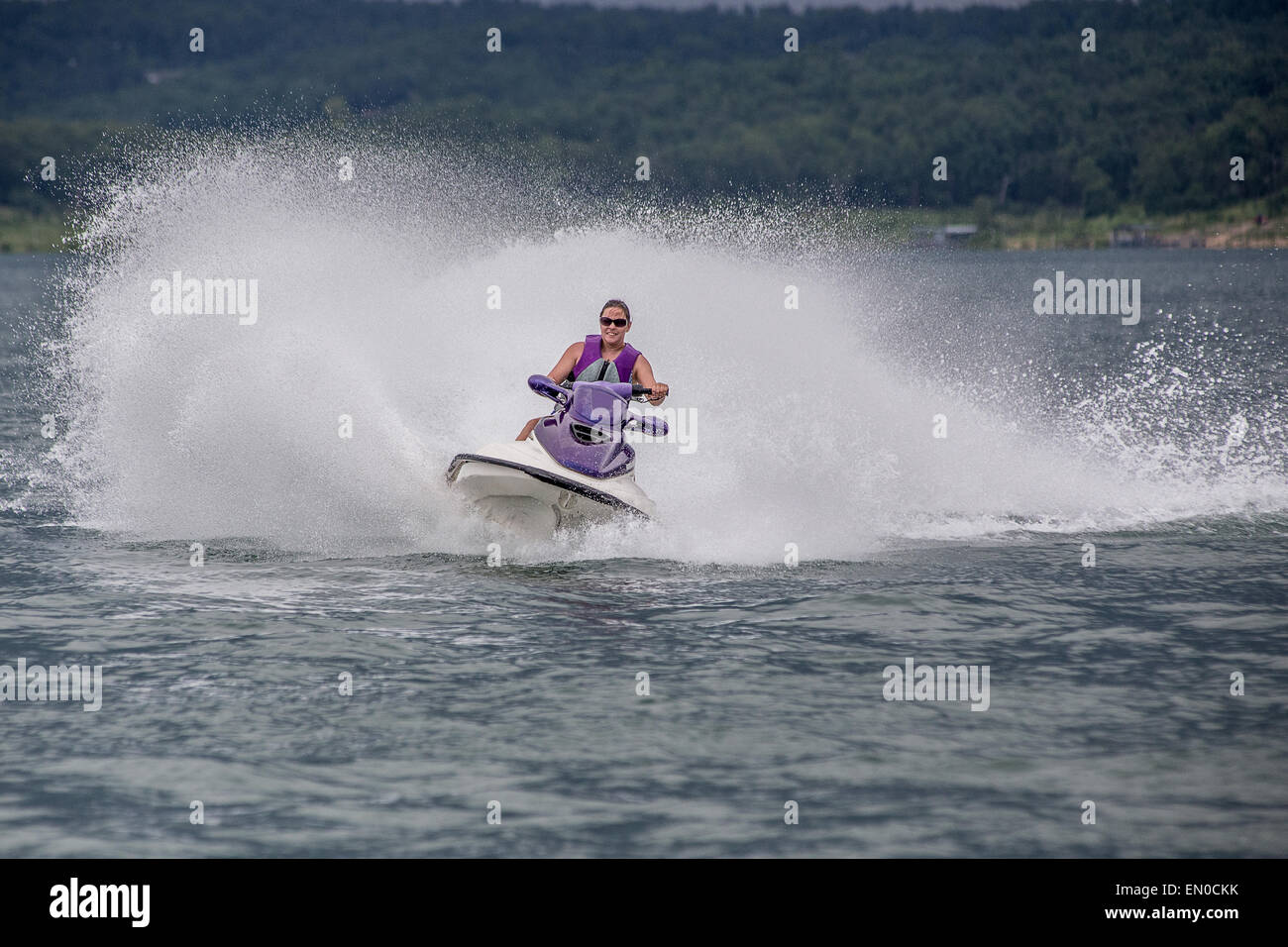 Young woman riding a jet boat at the lake Stock Photo - Alamy