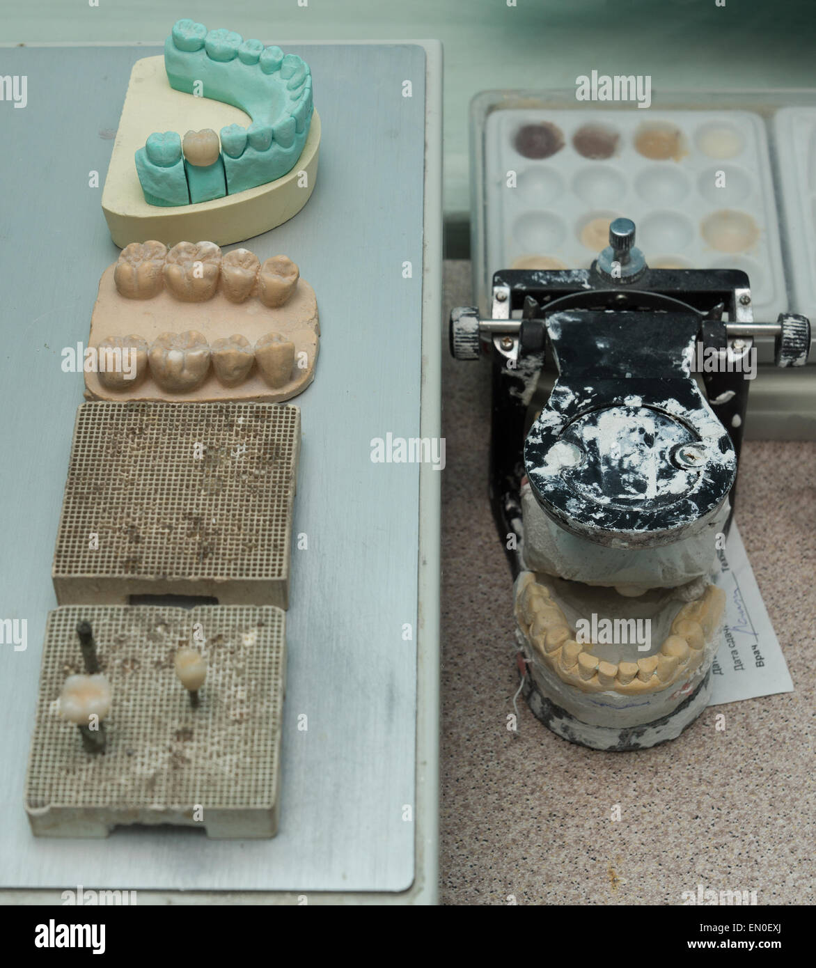 Workplace of the dental technician with models of tooth alignments and ...