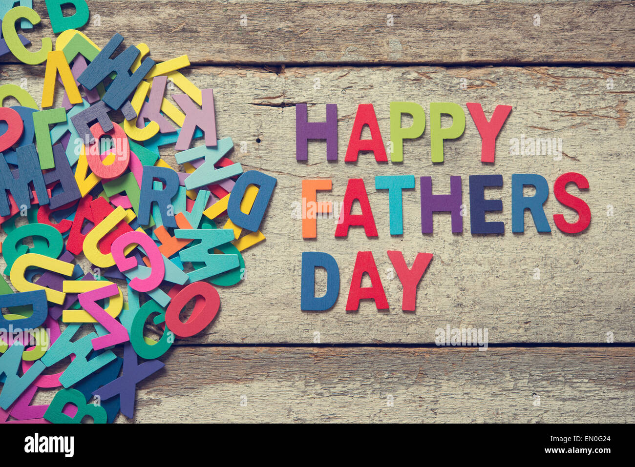 The colorful words "HAPPY FATHERS DAY" on old wooden plank Stock Photo ...