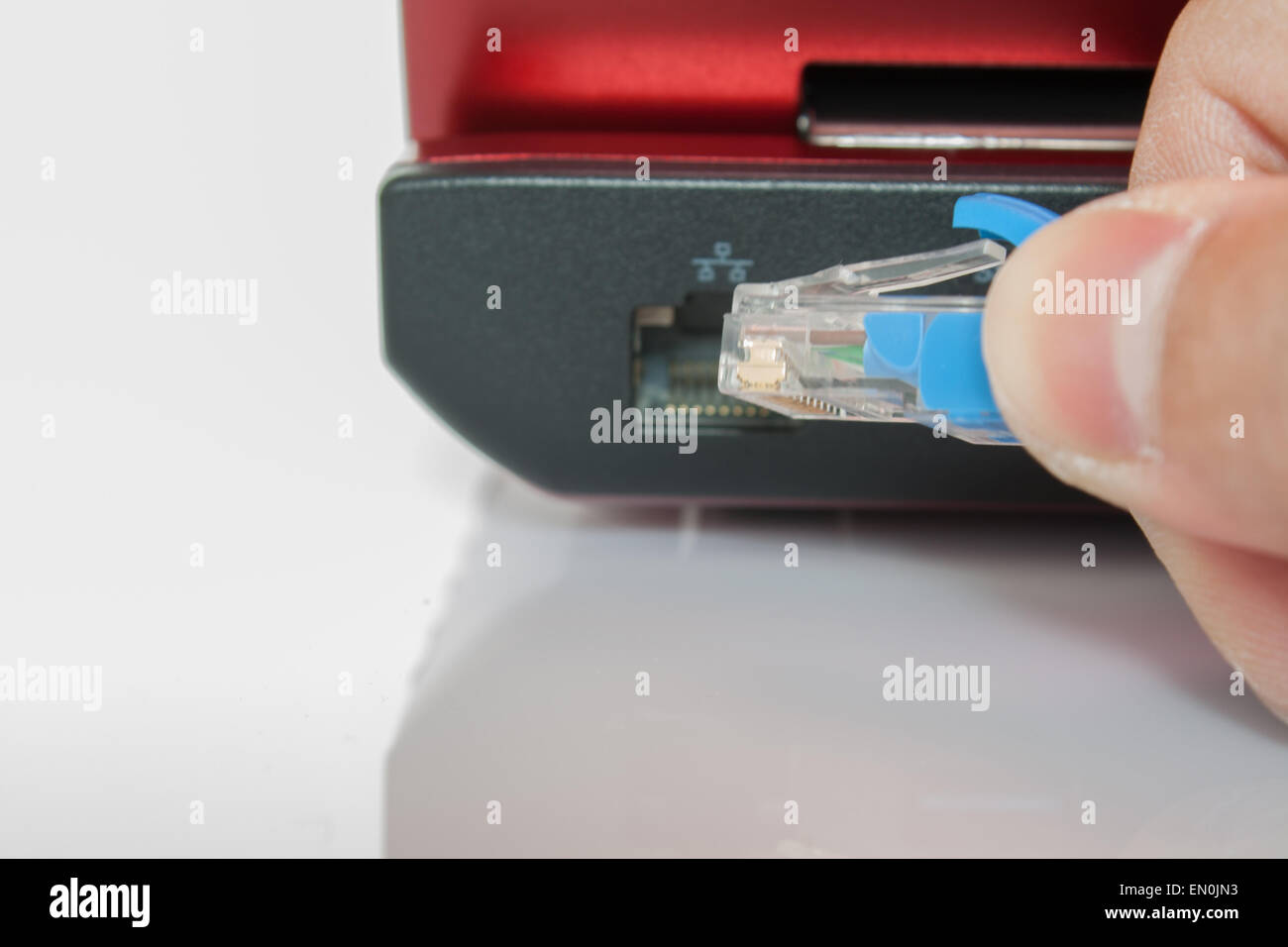 Connecting lan port to laptop computer isolated on white background ...