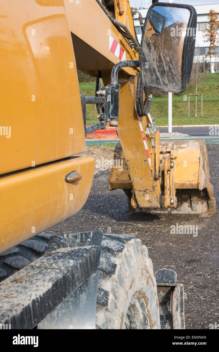 Muddy excavator shovel with rear-view mirror on building site Stock ...