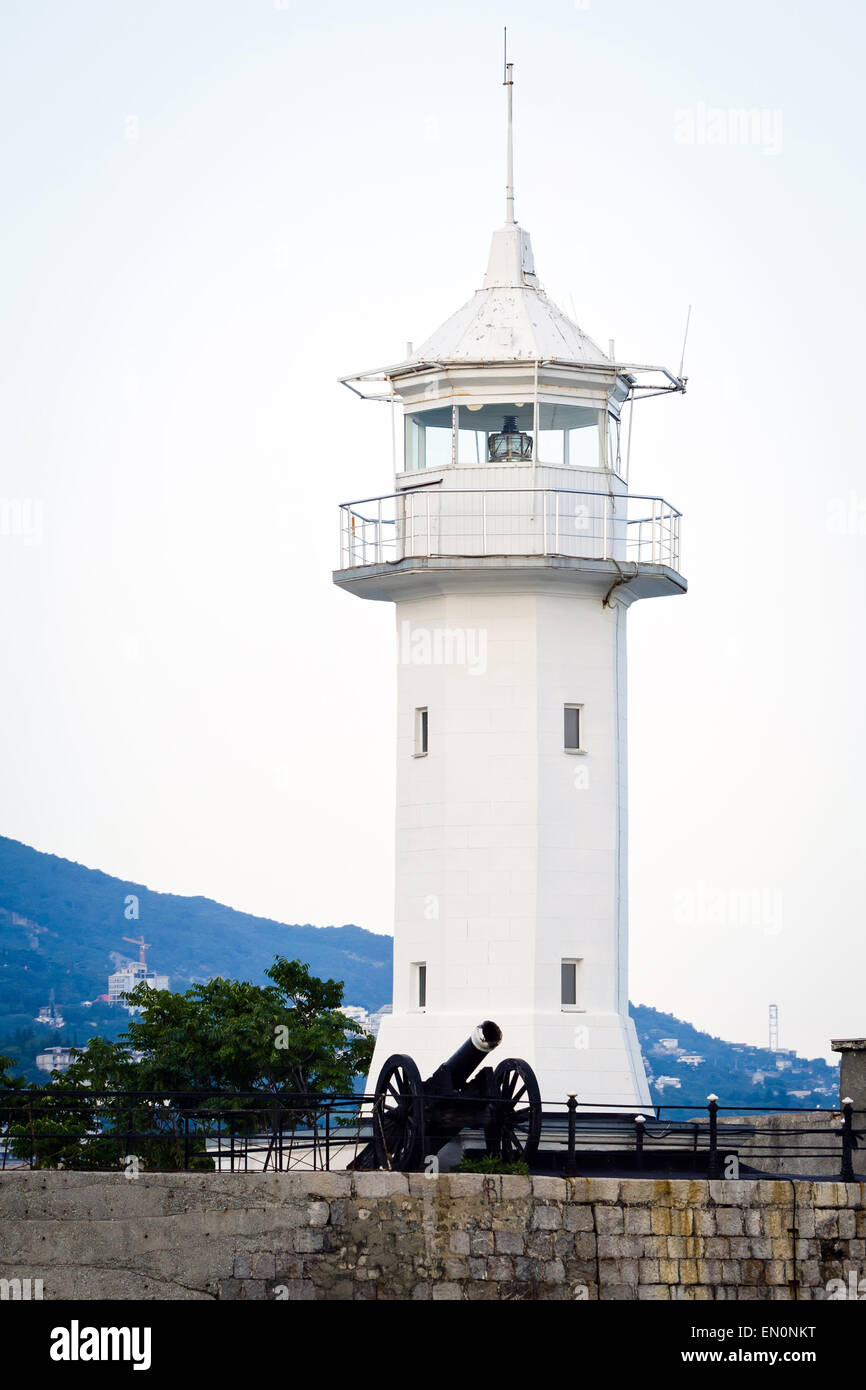 Lighthouse with an old cannon Stock Photo - Alamy