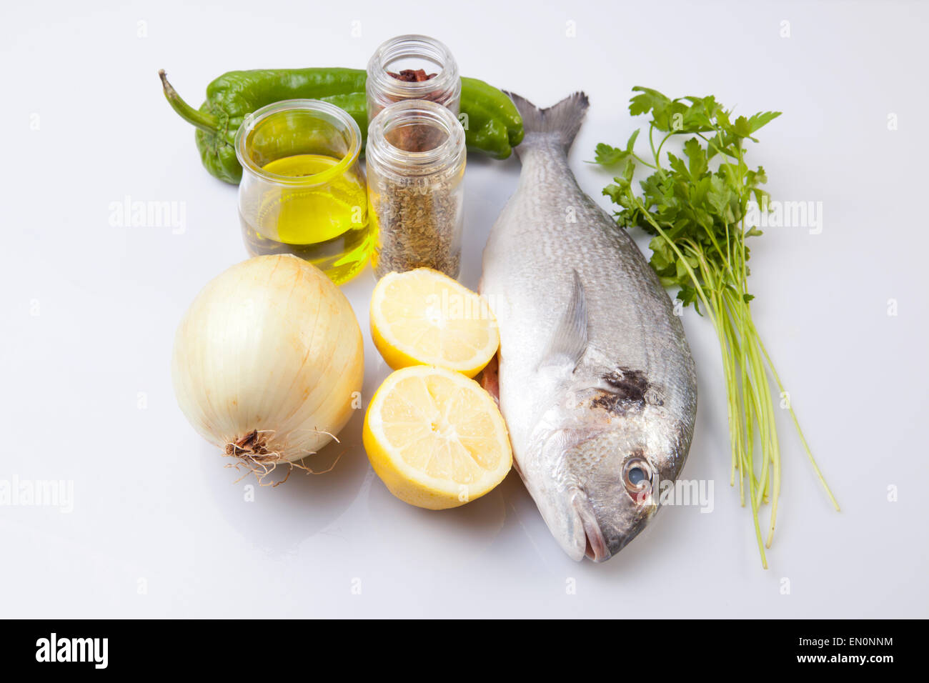 Raw sea bream fish with some ingredients. Isolated over white ...