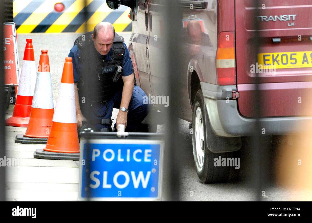 London, England, UK. Police officer checking a vehicle entering Downing ...