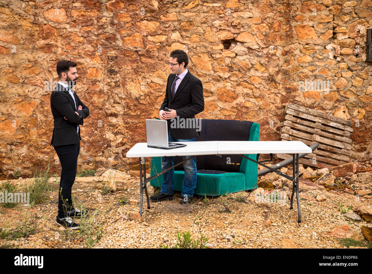 Two guys discussing a business issue in a grunge office Stock Photo - Alamy