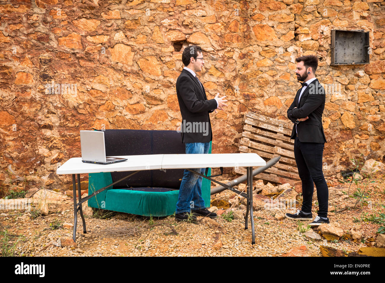 Two guys discussing a business issue in a grunge office Stock Photo - Alamy