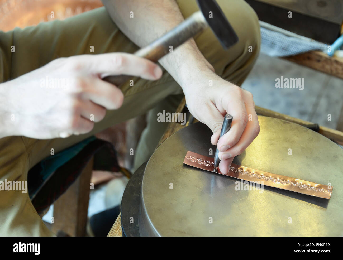 Craftsman makes copper bracelet Stock Photo - Alamy