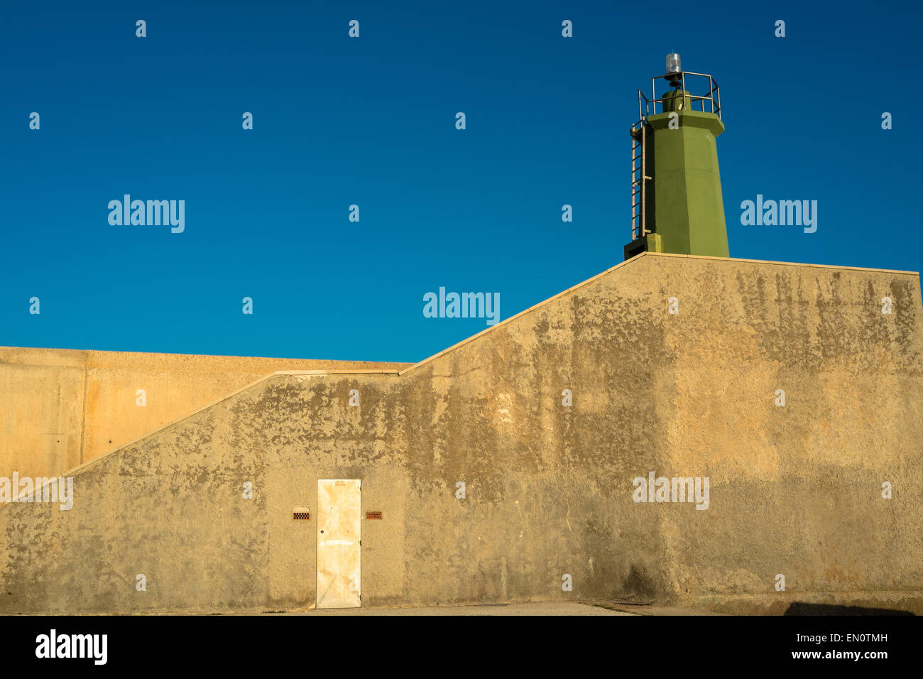 Green beacon on top of a concrete wall Stock Photo - Alamy