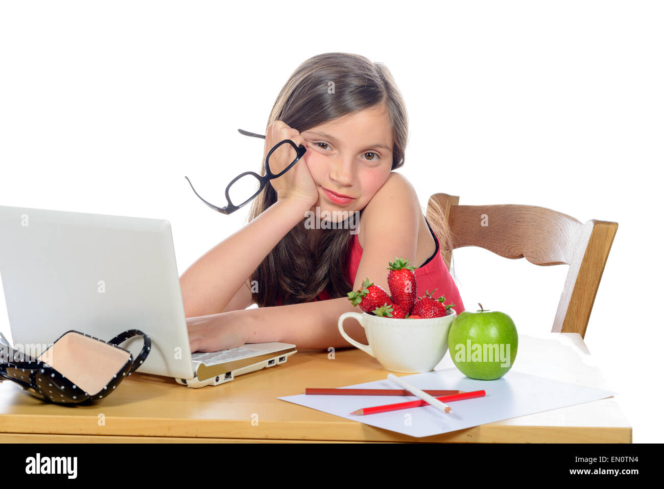 a little girl doing her homework on her computer on white Stock Photo ...