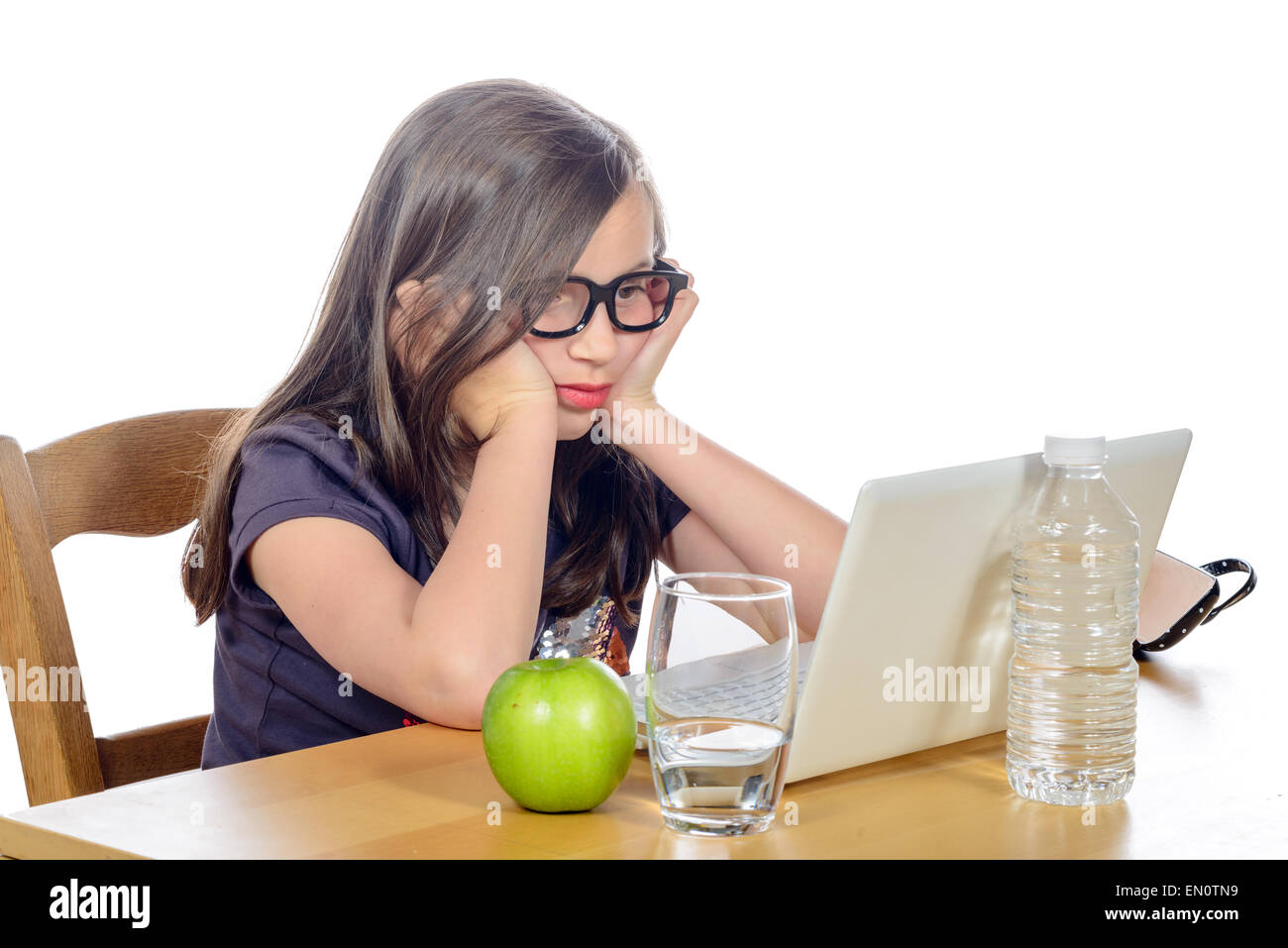 tired young girl in front of her laptop on white background Stock Photo ...