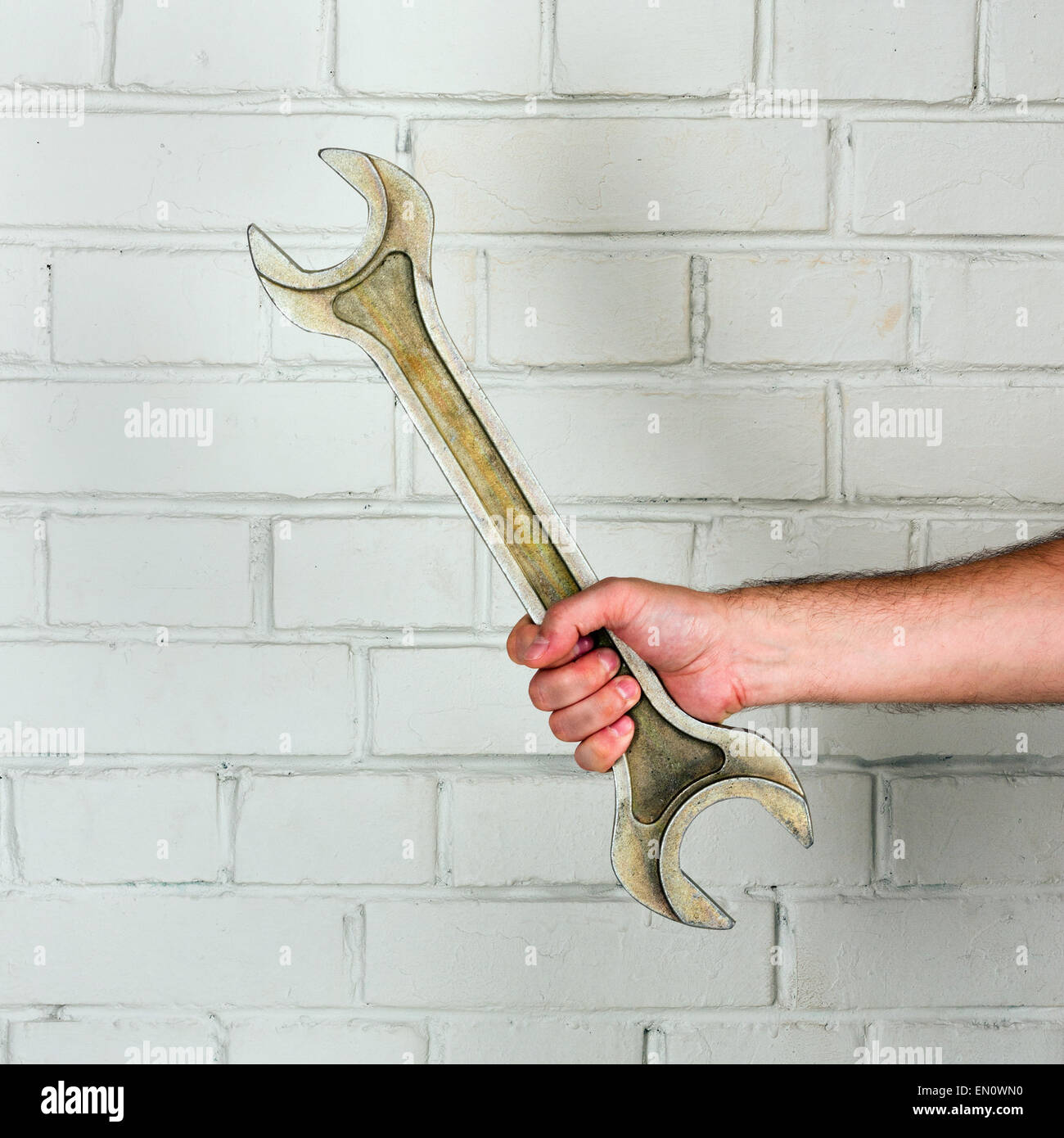 Big spanner in a man hand. Helping hand Stock Photo - Alamy