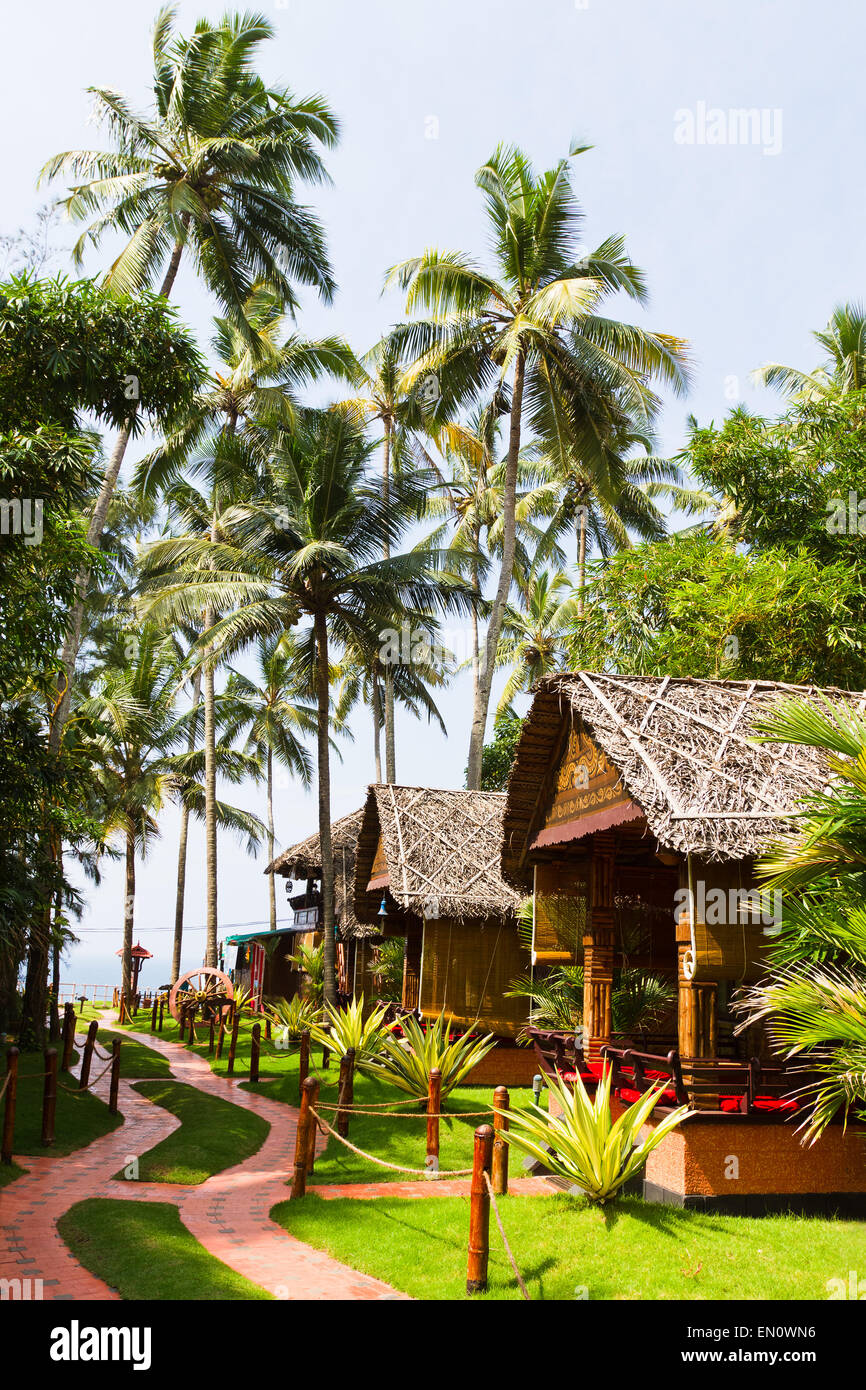 Bungalows and pathway. Vacation background with palm trees Stock Photo ...