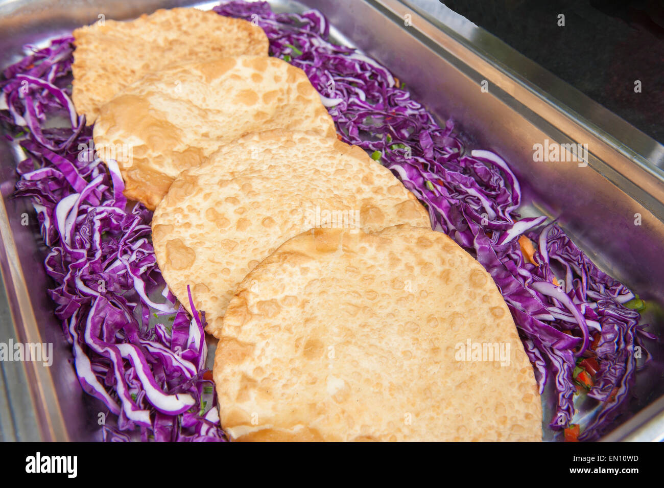 Closeup detail of four fried indian naan bread on display at a ...