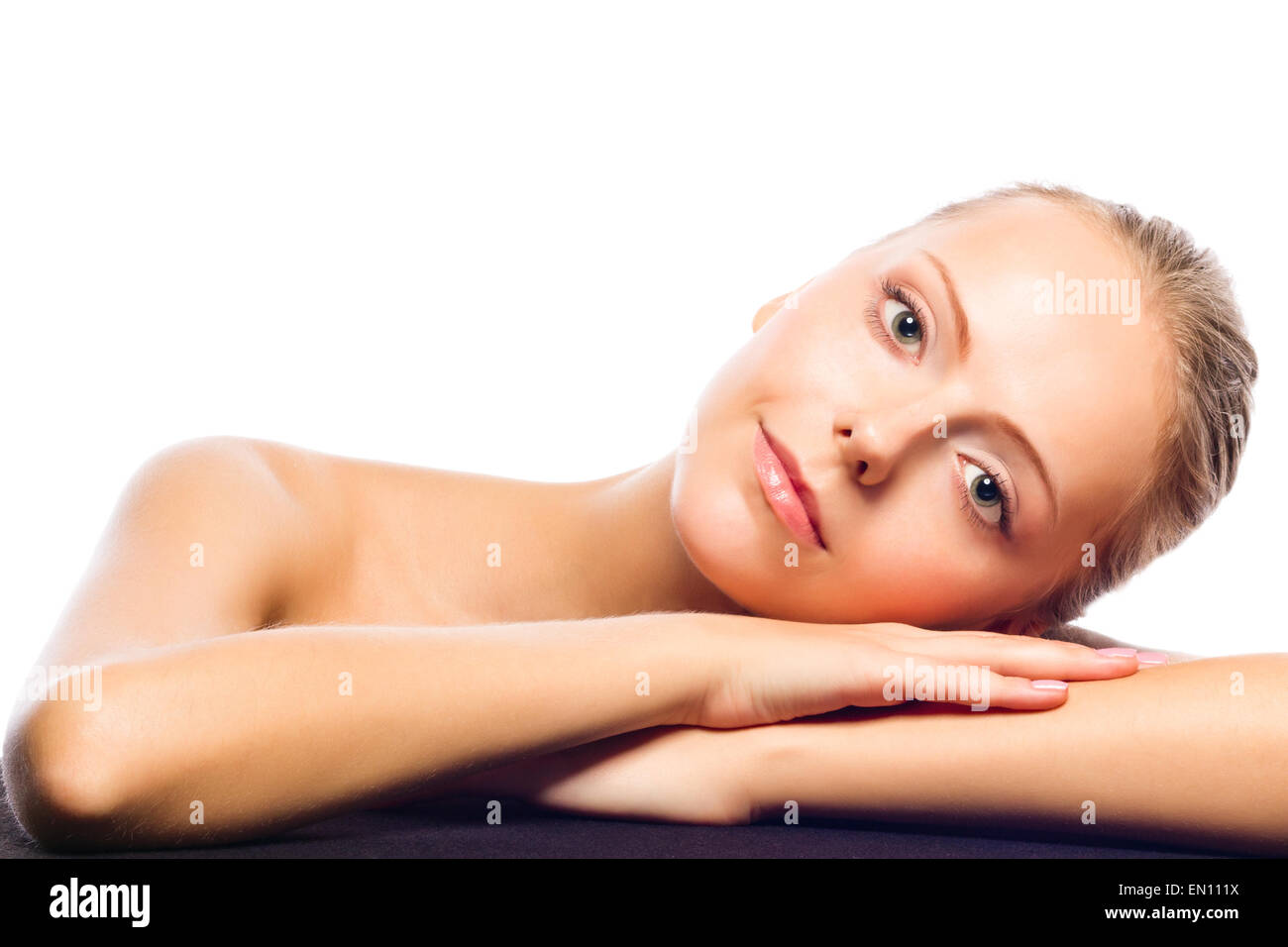 Attractive young woman lying on her hands. Isolated over white ...