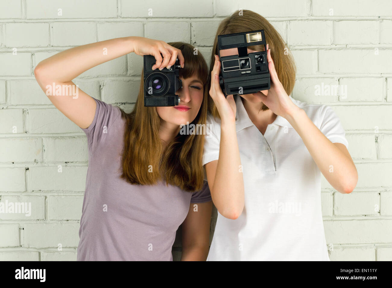 Young women taking picture with a old vintage cameras Stock Photo - Alamy