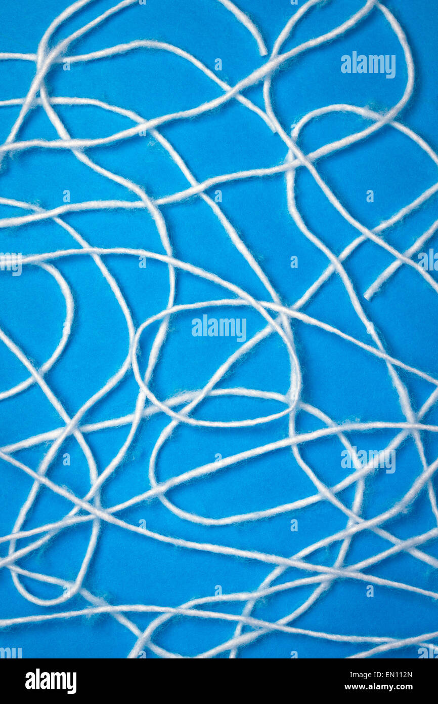 Abstract white wool strings on blue background Stock Photo - Alamy