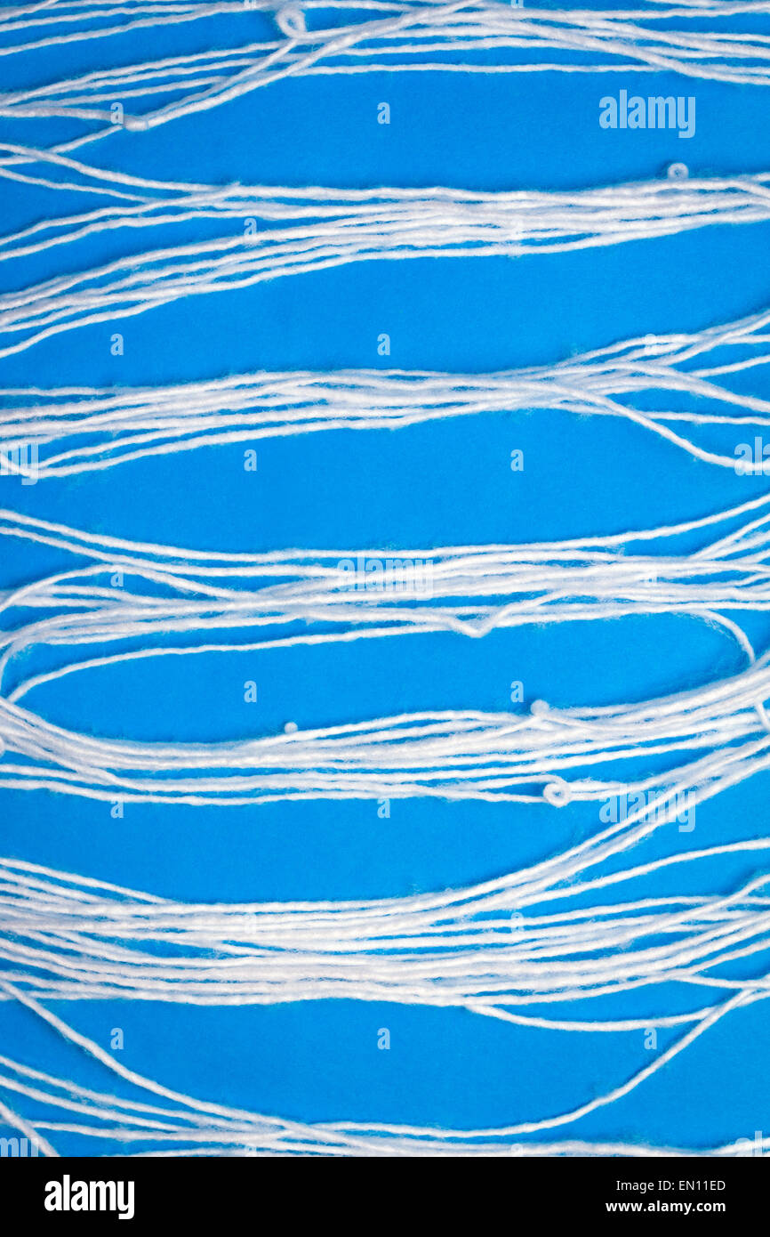 Abstract white wool strings on blue background with copy space Stock ...