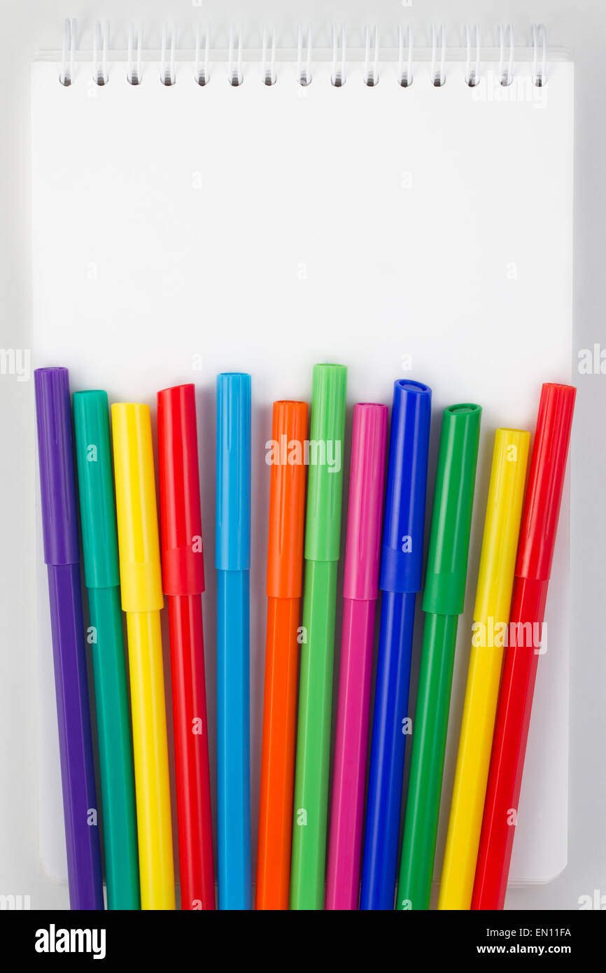 Colored marker pens on a white notepad with copy space Stock Photo - Alamy