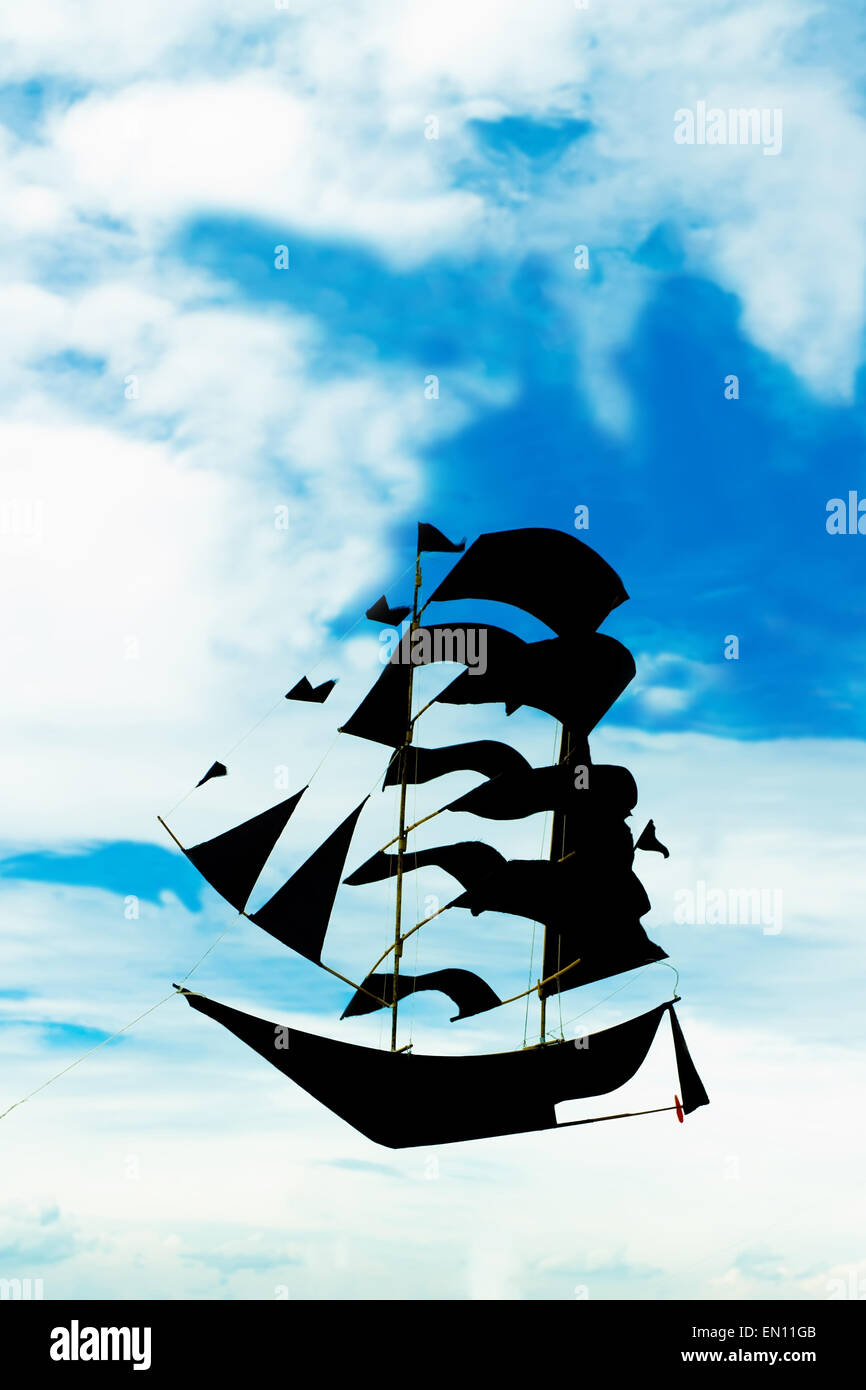 Pirate ship kite flying against blue sky and clouds Stock Photo - Alamy