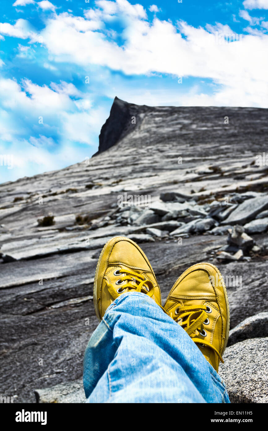 Woman's legs relaxing in mountain landscape with clouds Stock Photo - Alamy