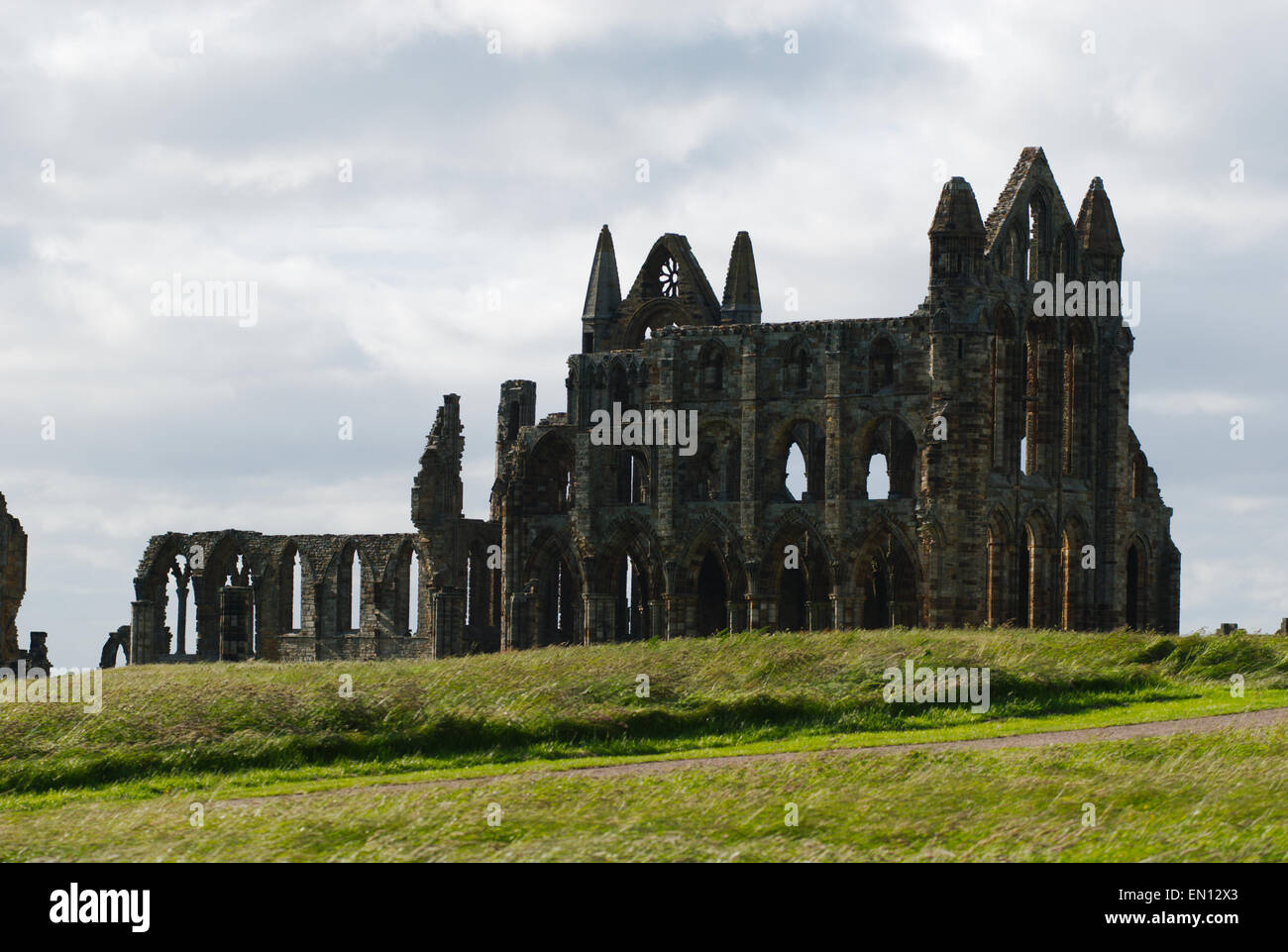 The ruins of Whitby Abbey glow in the setting sun, Whitby, England ...
