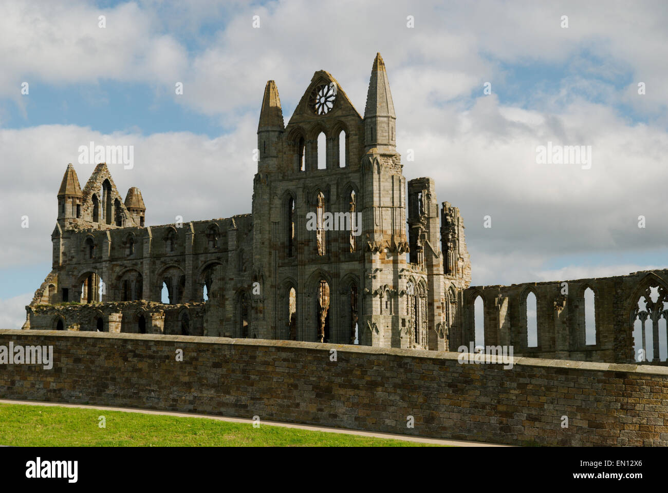 The ruins of Whitby Abbey glow in the setting sun, Whitby, England ...
