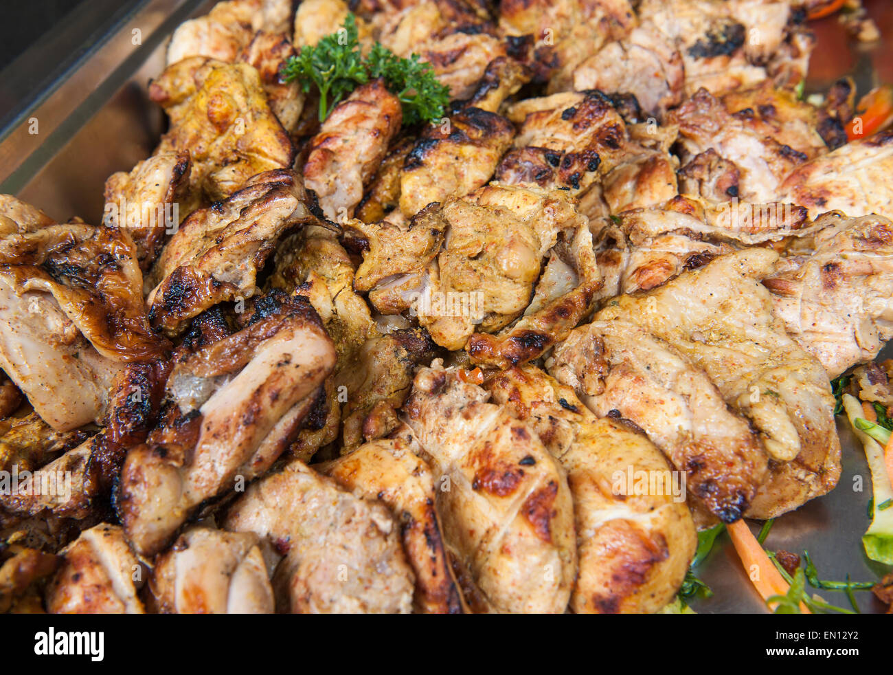 Grilled chicken pieces on display at an oriental restaurant buffet ...