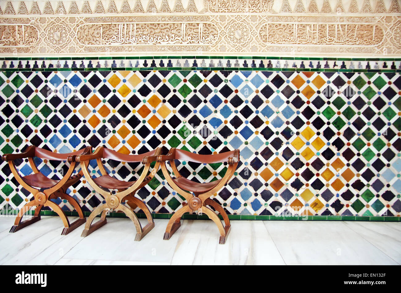 Chairs and the wall of tiles in The Alhambra, Granada, Spain Stock ...