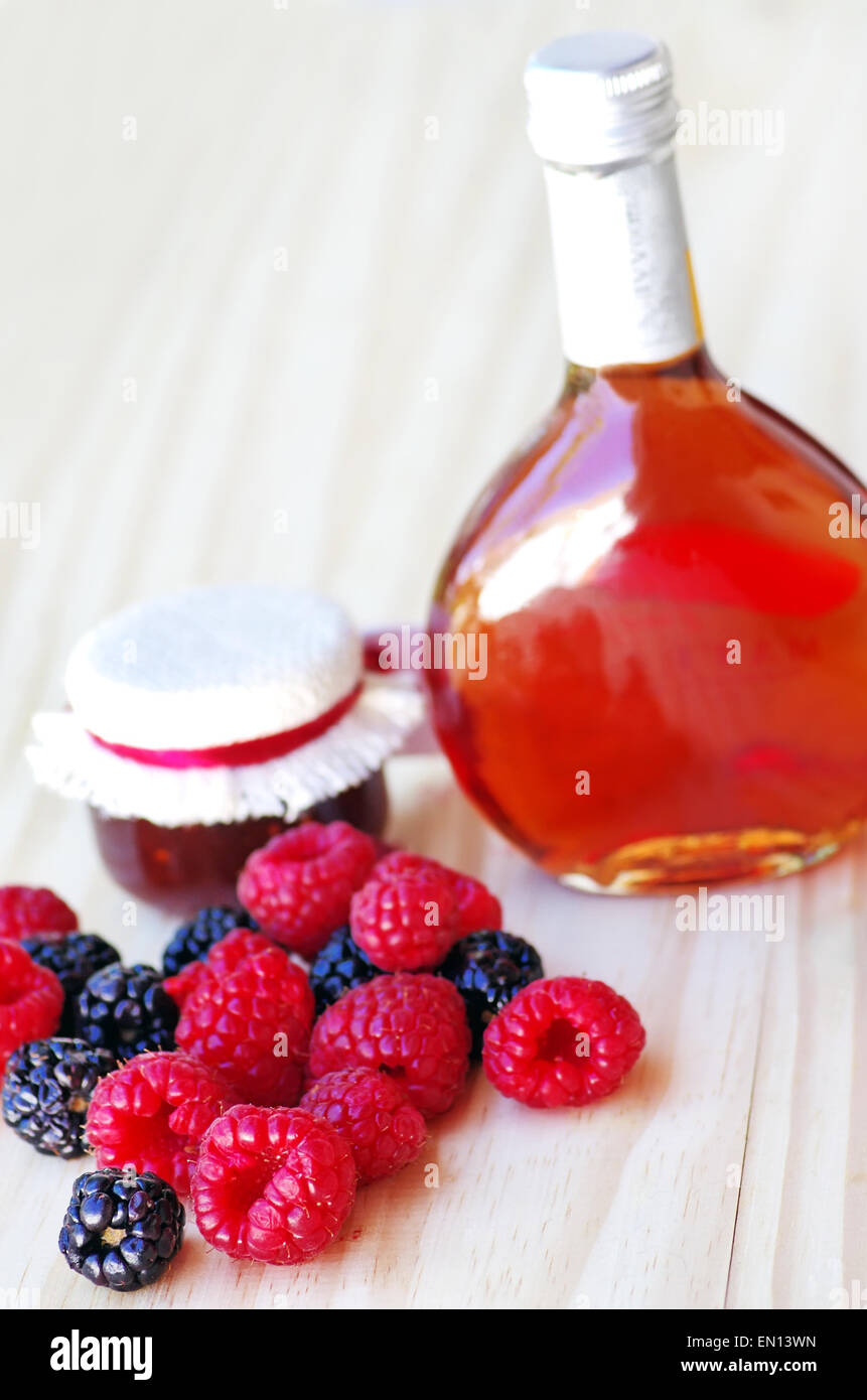 raspberry fruits and wine bottle Stock Photo - Alamy