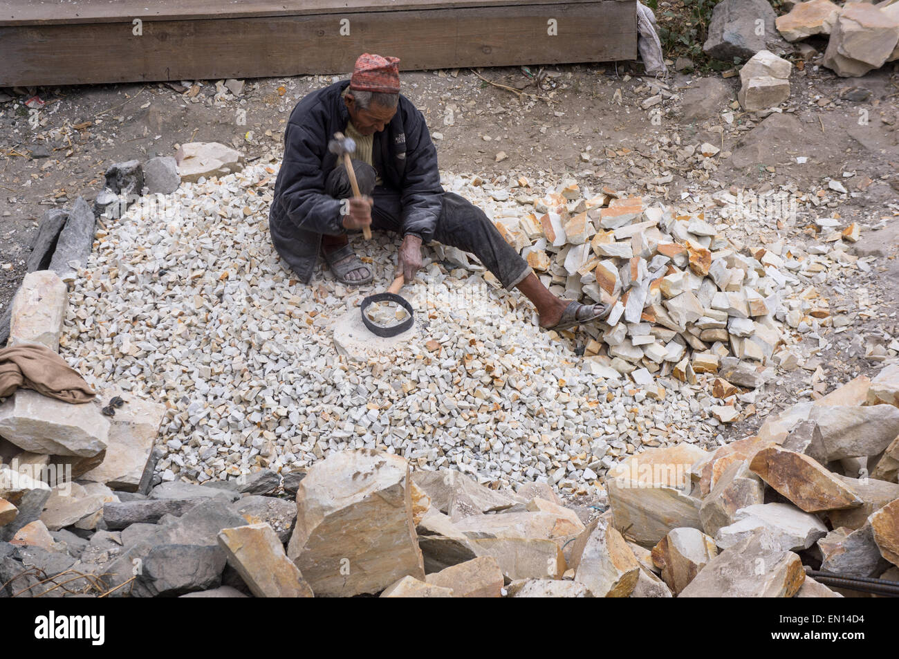 Nepalese Man Crushing Stones by Hand in the Annapurna Region, Nepal ...