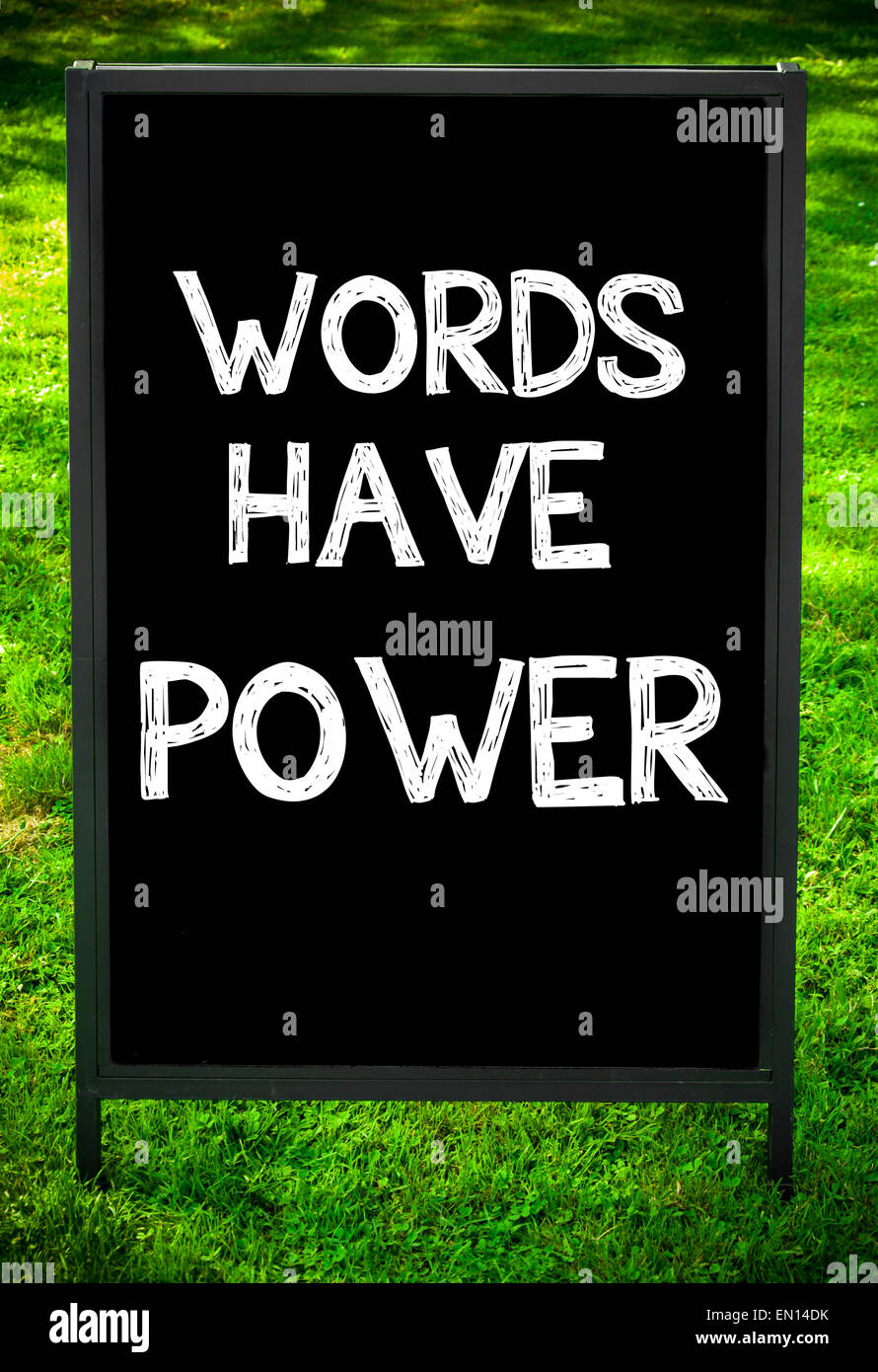 WORDS HAVE POWER message on sidewalk blackboard sign against green ...
