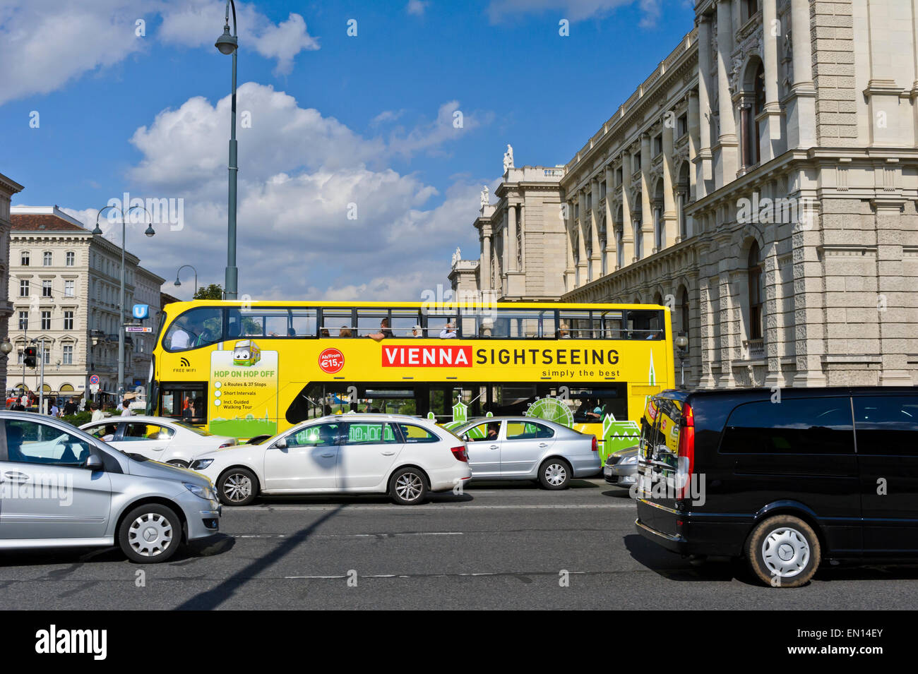 A yellow sightseeing bus in rush hour traffic in Vienna, Austria Stock ...