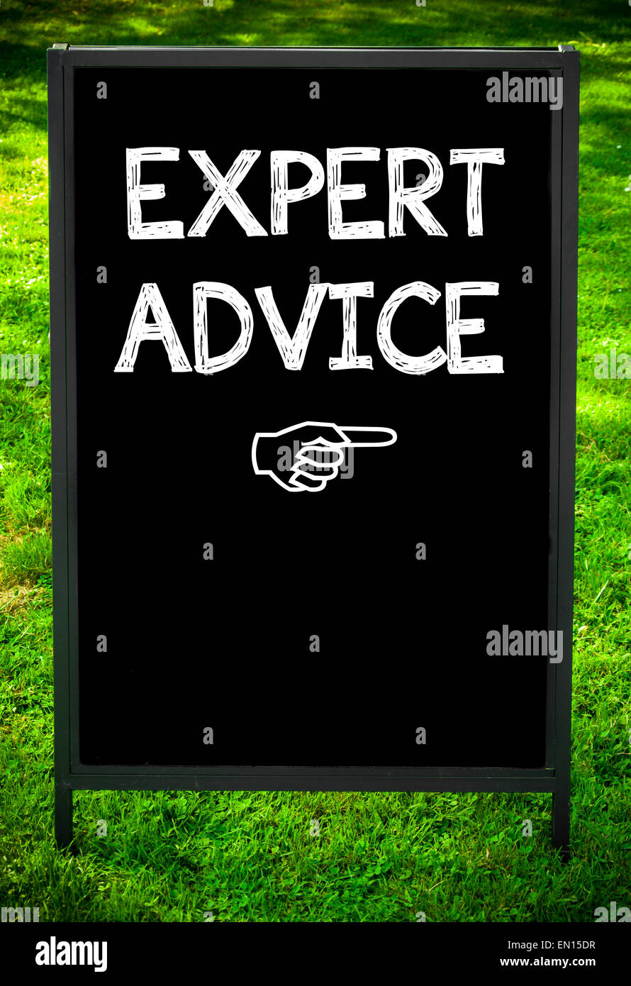 EXPERT ADVICE message on sidewalk blackboard sign against green grass ...