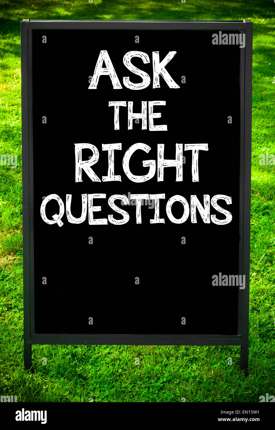 ASK THE RIGHT QUESTIONS message on sidewalk blackboard sign against ...