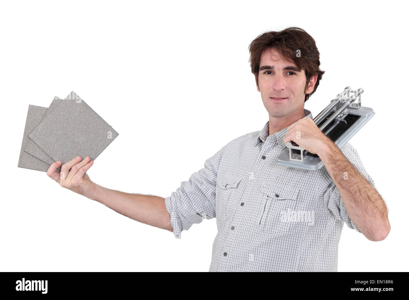 Man holding tile cutter Stock Photo - Alamy
