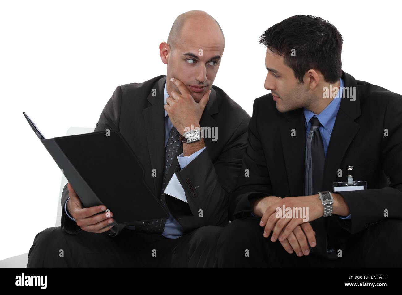 Businessmen discussing a file Stock Photo - Alamy