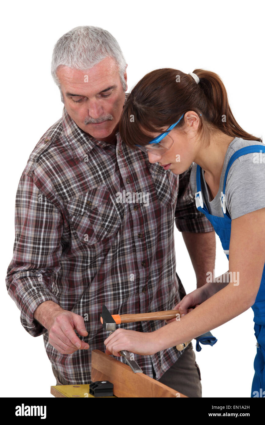 Carpenter teaching young apprentice Stock Photo - Alamy