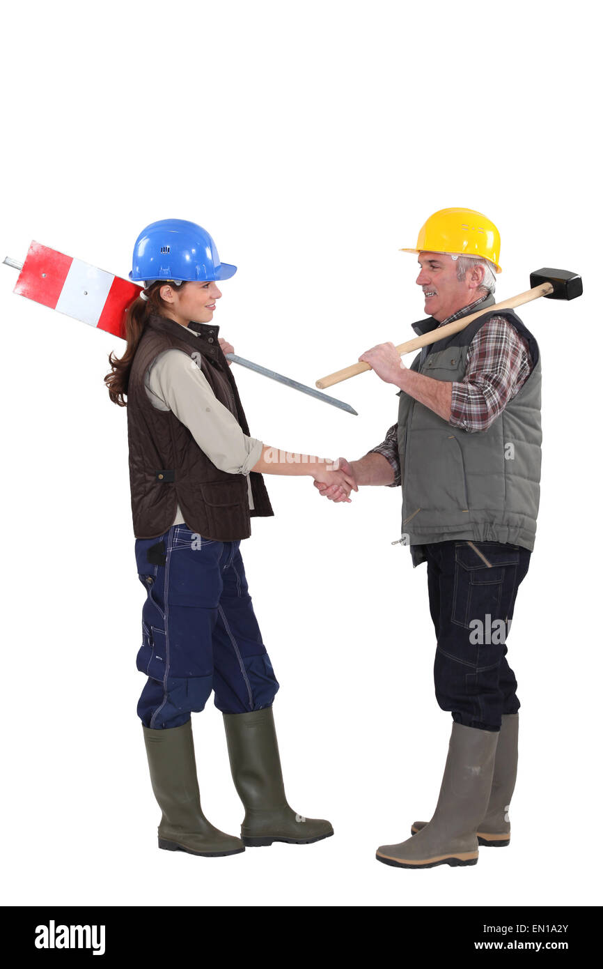 Construction workers shaking hands Stock Photo - Alamy