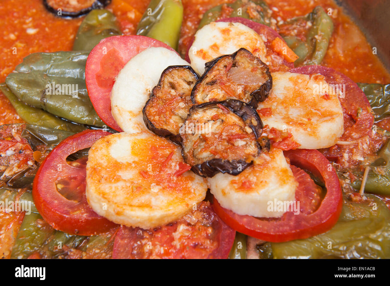 Closeup detail of oriental vegetables in tomato sauce on display at a ...