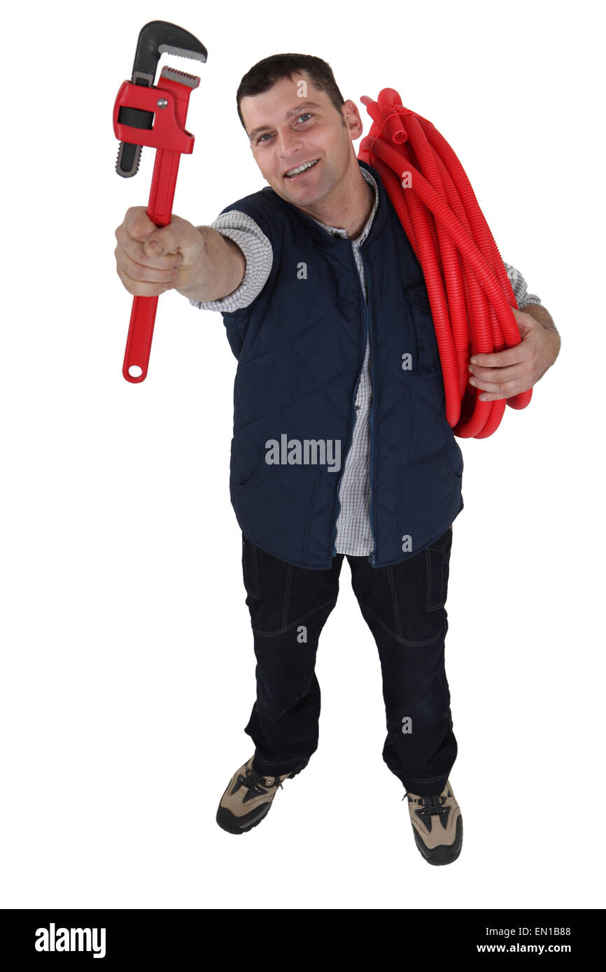 A male plumber presenting a wrench Stock Photo - Alamy